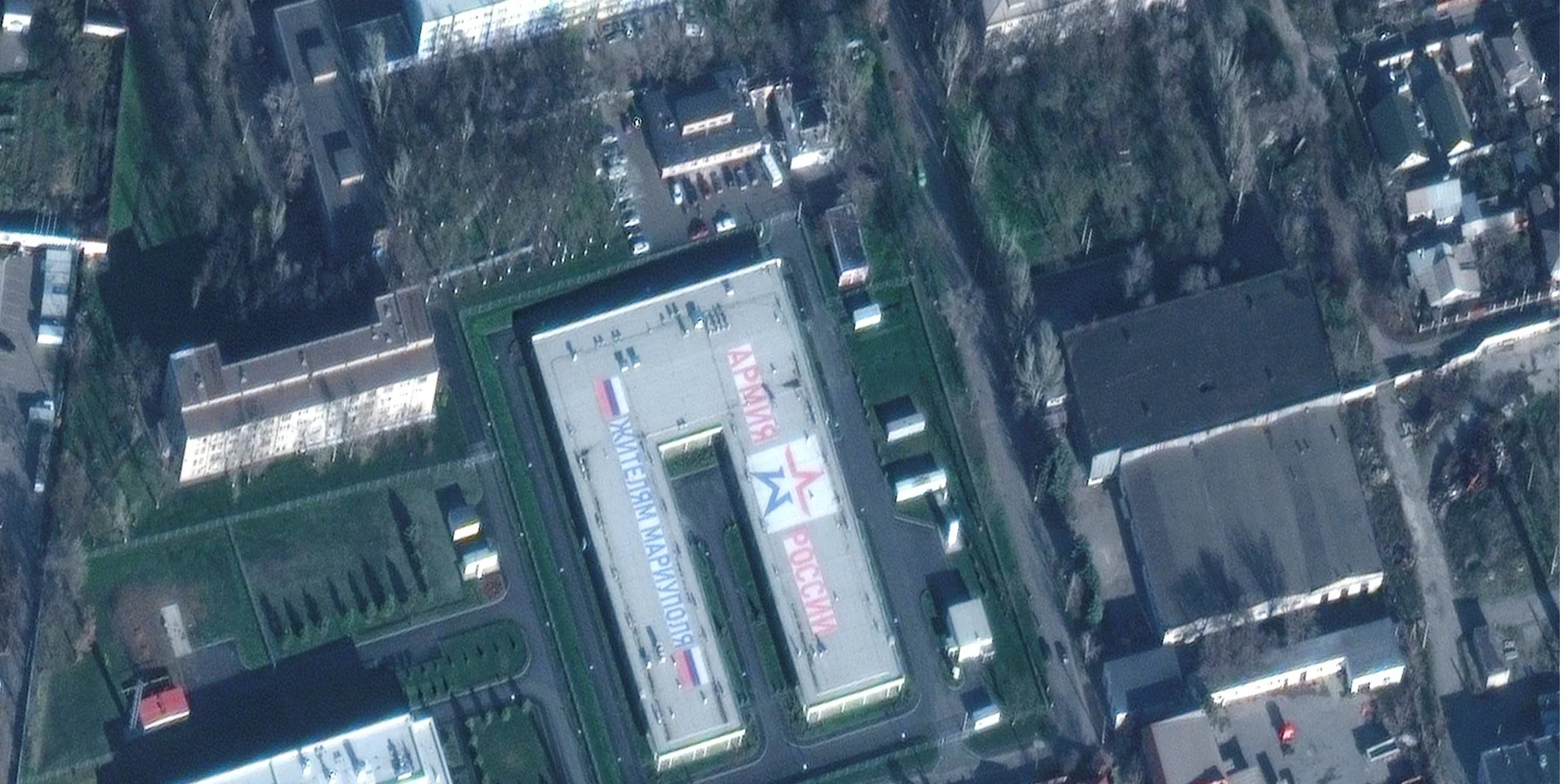 New military base in Mariupol with Russian flag and star on roof / The ...