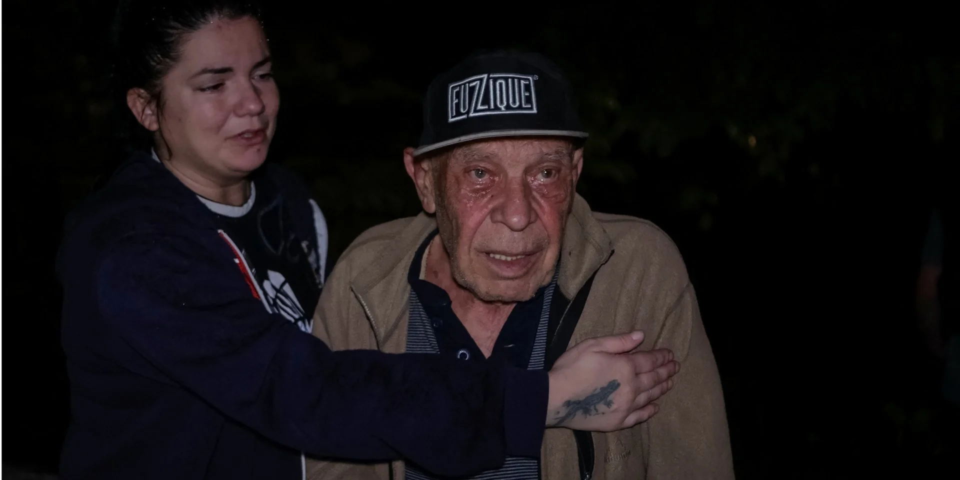 Strike on Kharkiv - Relatives console a man near the entrance destroyed by the Russian strike ...