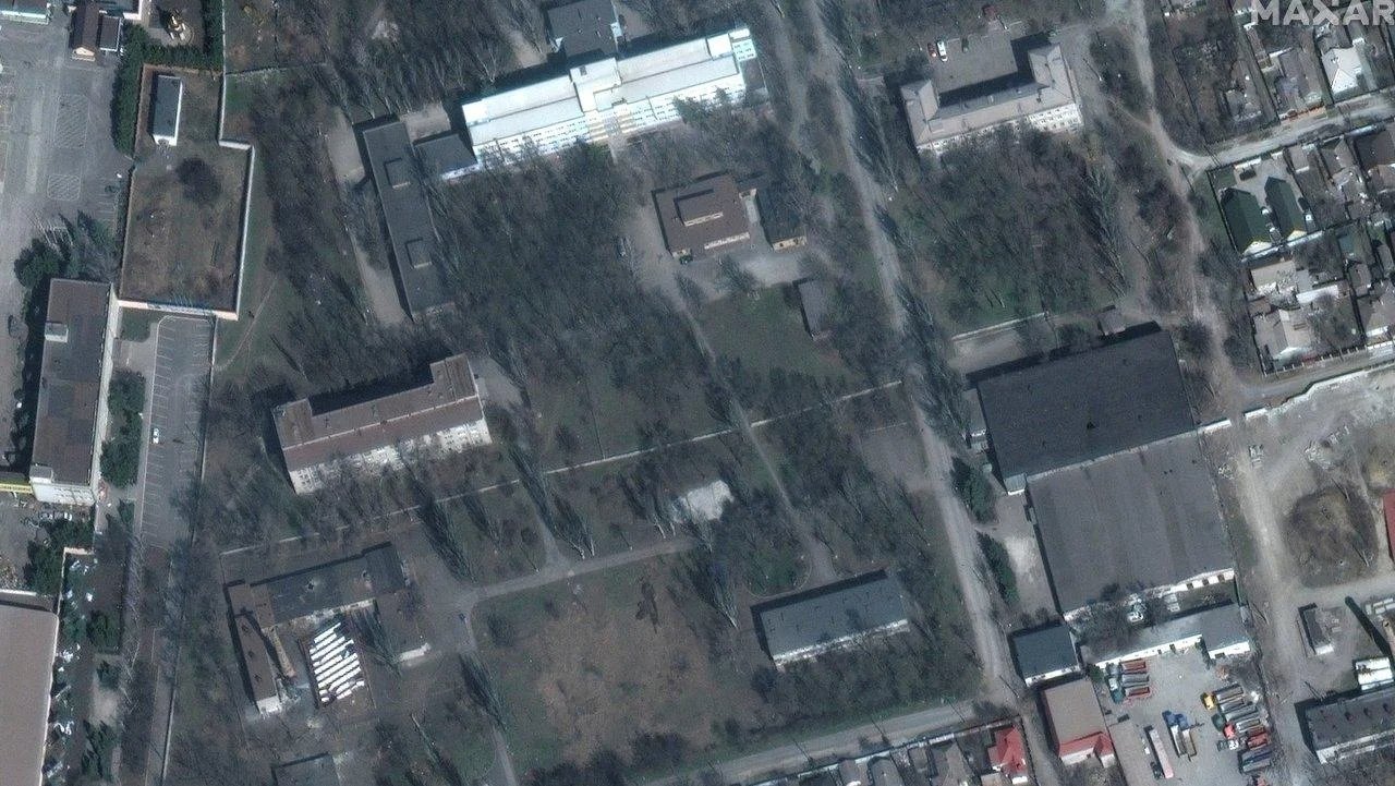 New military base in Mariupol with Russian flag and star on roof / The ...